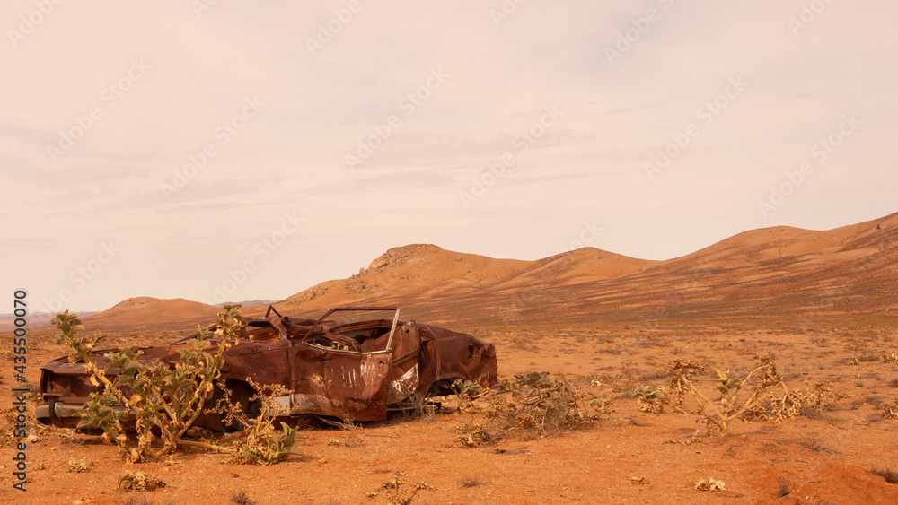 Abandoned rusted car wreck in a desert. The car rolled in the accident ...