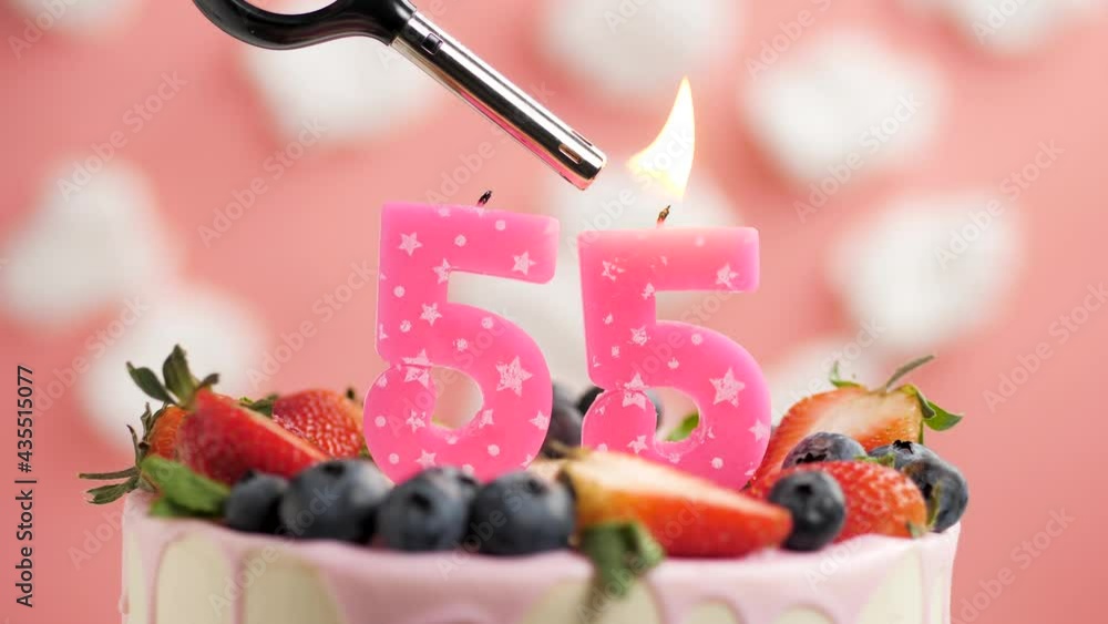 Birthday cake candle number 55. Candle and cake on pink background and ...