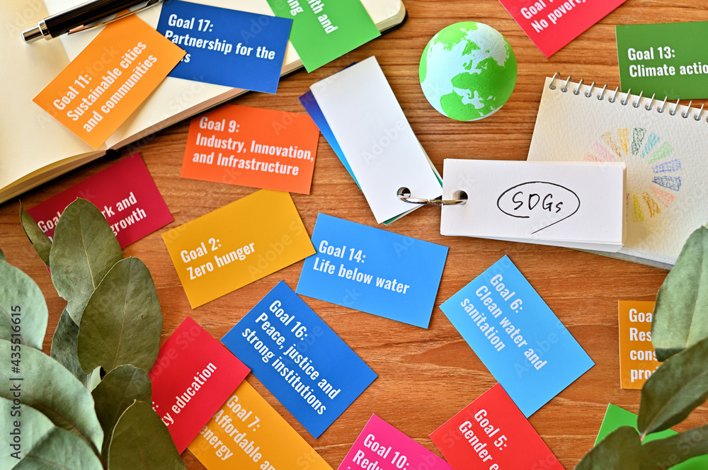Fotografia do Stock: There is a table with a card with the SDG goals ...