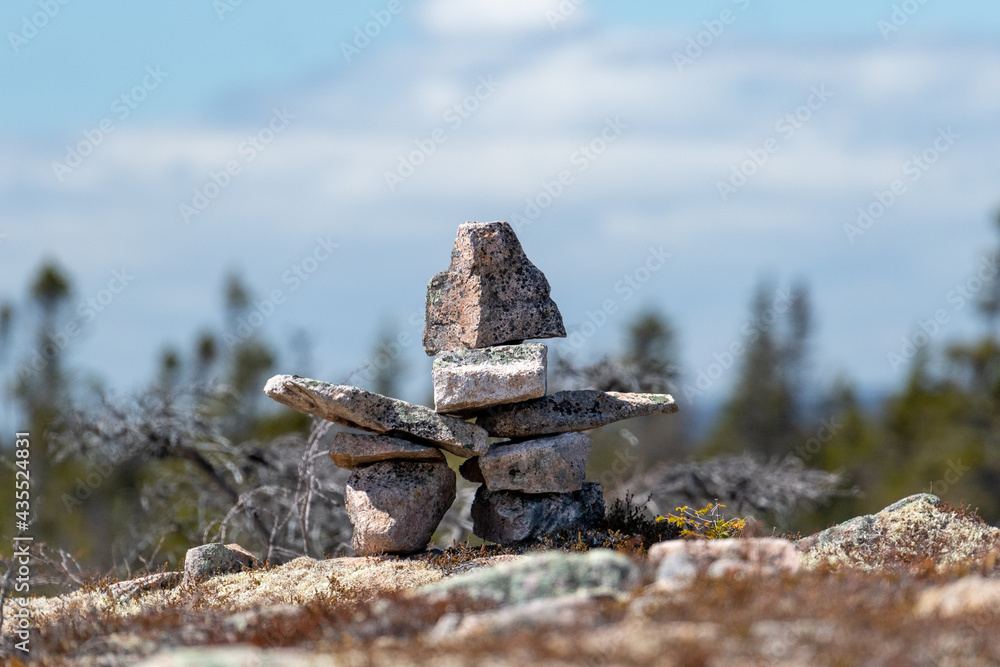 Inukshuk, a stack of granite rocks in the form of a person. The ...