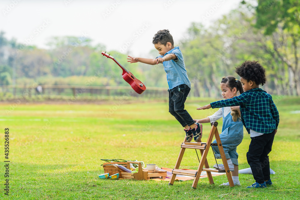 multi ethnic and diverse group of children playing together in park ...