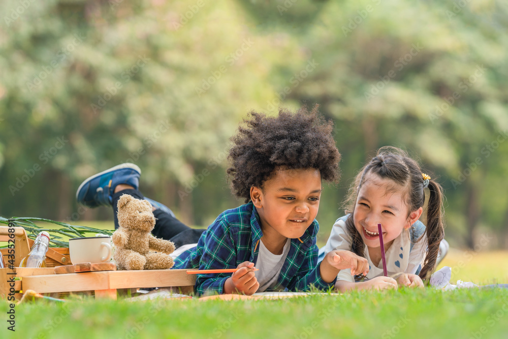 diverse mixed race kids as friends have fun together during picnic in ...