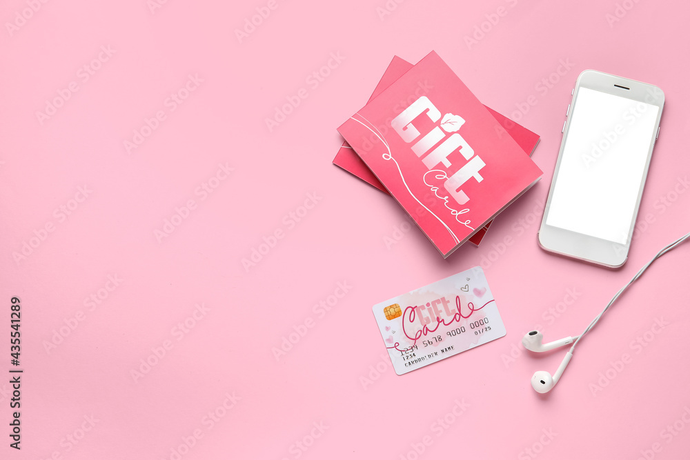 Gift card and mobile phone on color background Stock Photo | Adobe Stock