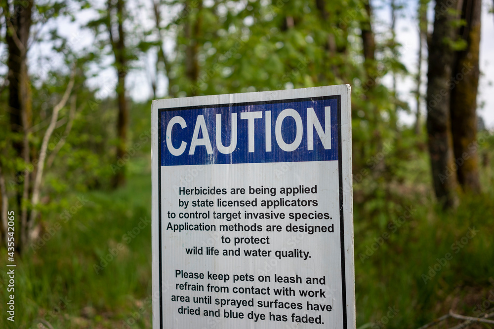 Caution sign informing visitors of herbicides being applied to control ...