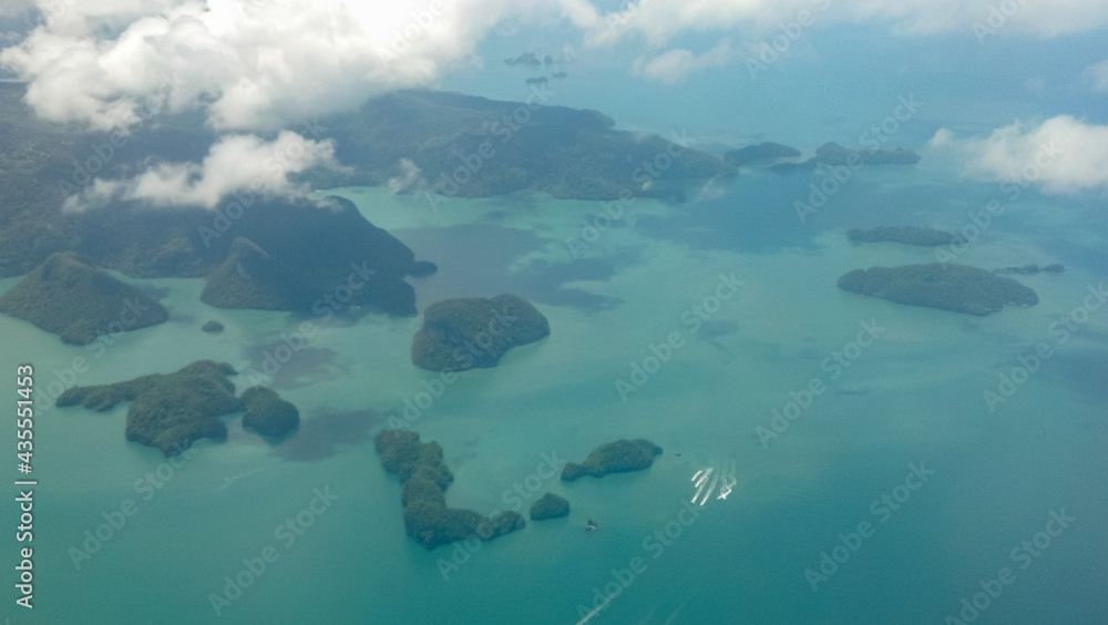 View from above on many green islands, sea and clouds. Aerial view of ...