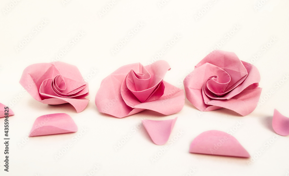 Origami paper background with flowers and leaves. Handmade pink roses ...