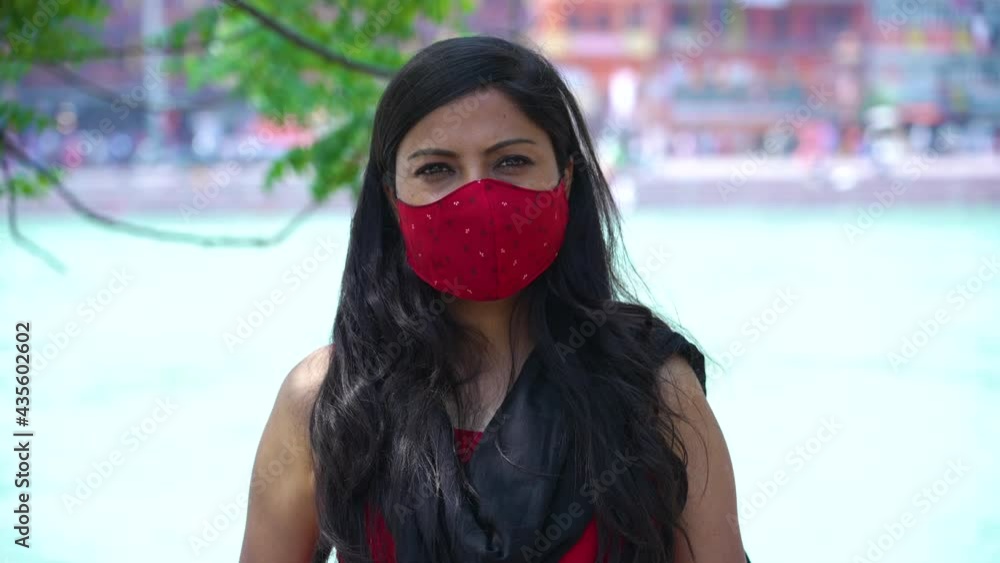 Indian Woman wearing Coronavirus protection face mask Holy river the ...