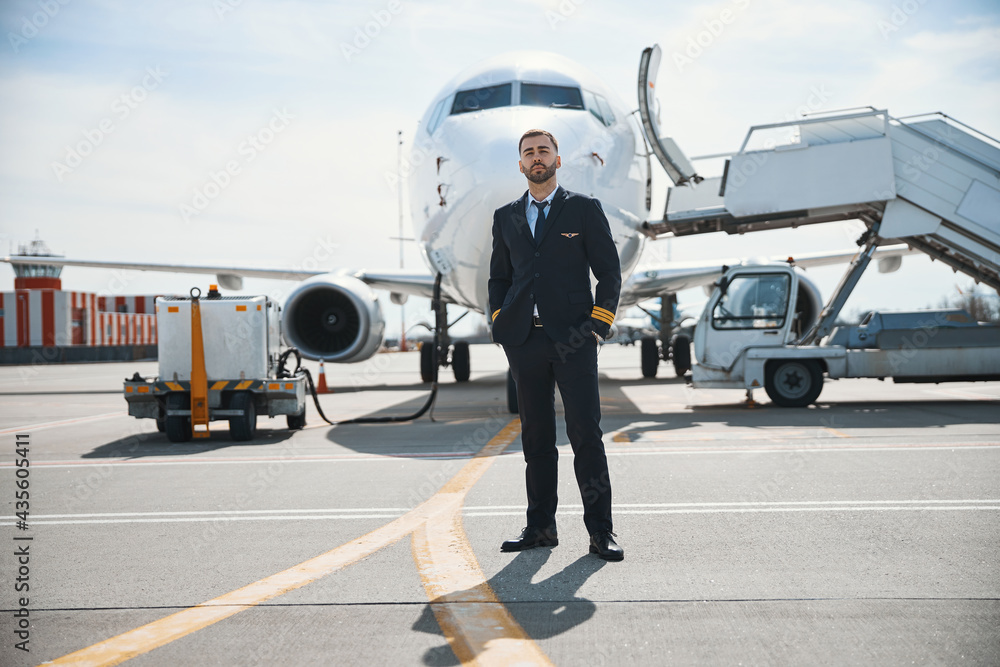 Captain standing while his plane preparing for flight Stock Photo ...