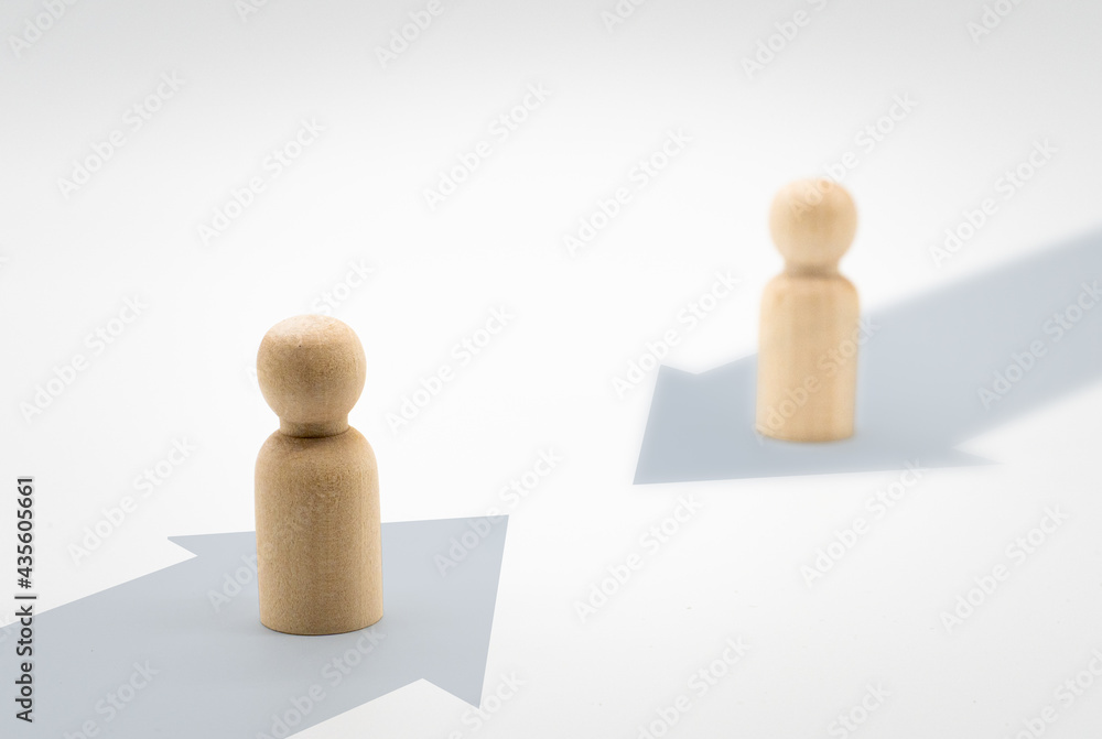 Wooden human arrow with joint venture arrow. Concept of team work ...