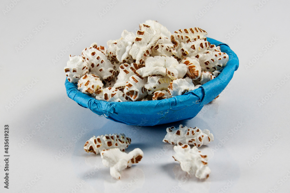 puffed rice and popped rice in Blue paper packet. local name in ...