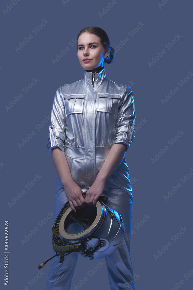 Female space explorer in spacesuit holding helmet Stock Photo | Adobe Stock