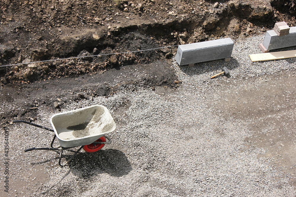 Road repairs. Installation of a new curb stone before laying asphalt ...