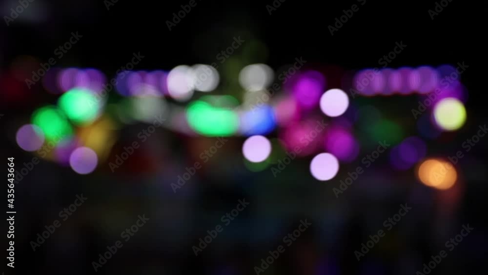 Blurry blinking lights of moving carousel ride at night Stock Video ...