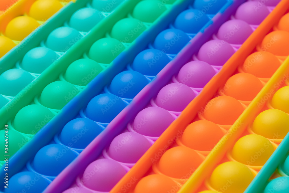 Pop it fidget. Colorful toy push pop it. Close up of antistress sensory ...