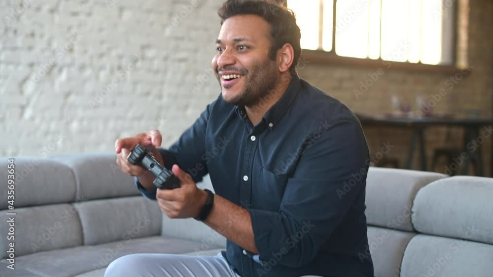 Indian guy winning in video game, excited happy hindu man sits on the ...