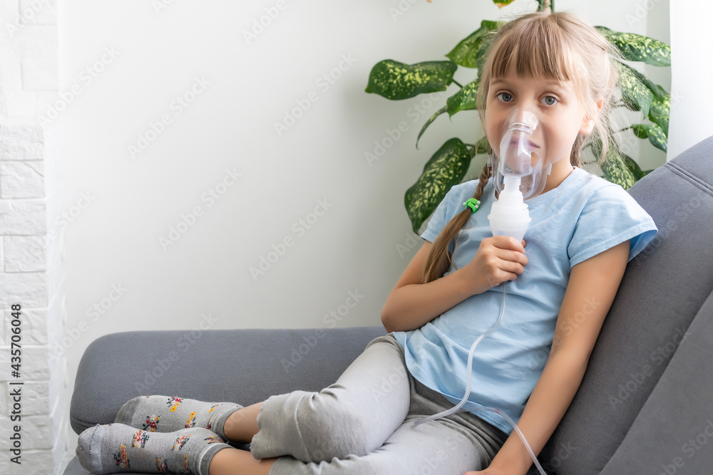 Little girl making inhalation with nebulizer at home. child asthma ...
