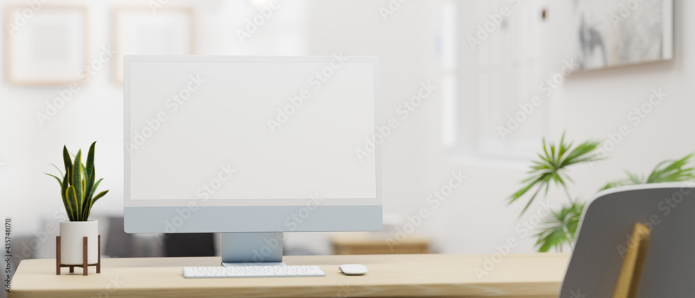 Blue pastel computer monitor with mock-up screen on the table in office ...