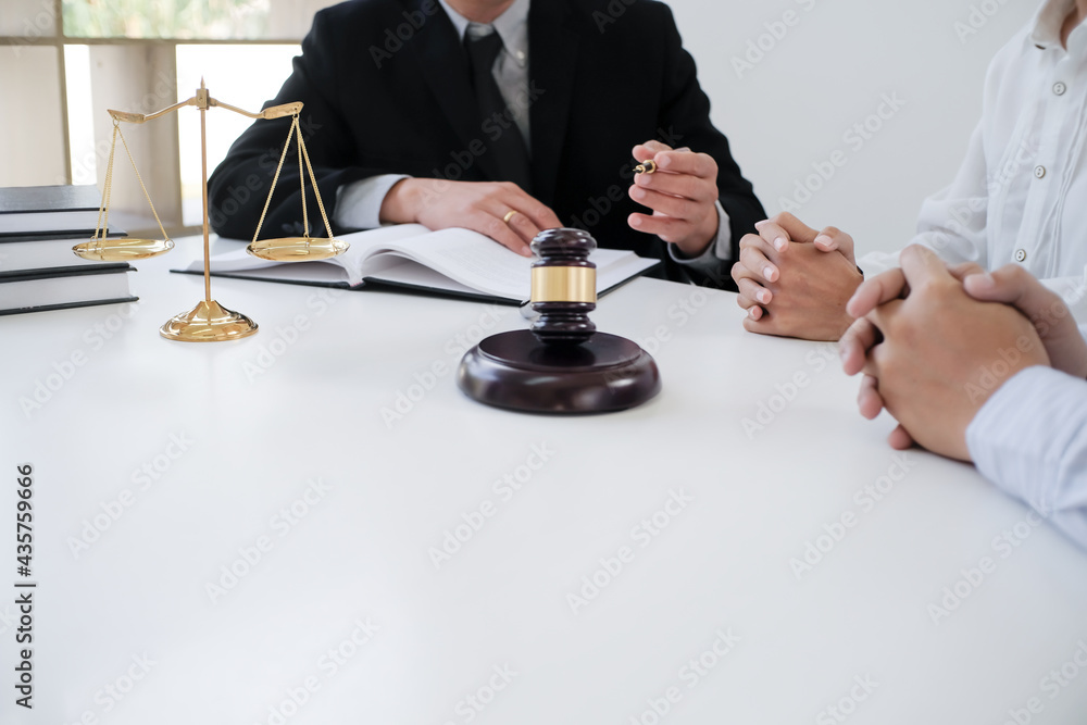 Legal counsel presents to the client a signed contract with gavel and ...