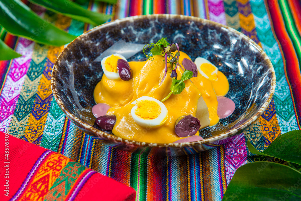 Papa a la Huancaina Peruvian boiled potatoes in hot sauce on a colorful ...