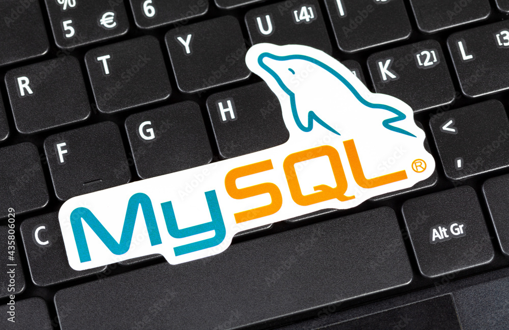 MySQL logo sticker laying on a laptop keyboard, object closeup, nobody ...