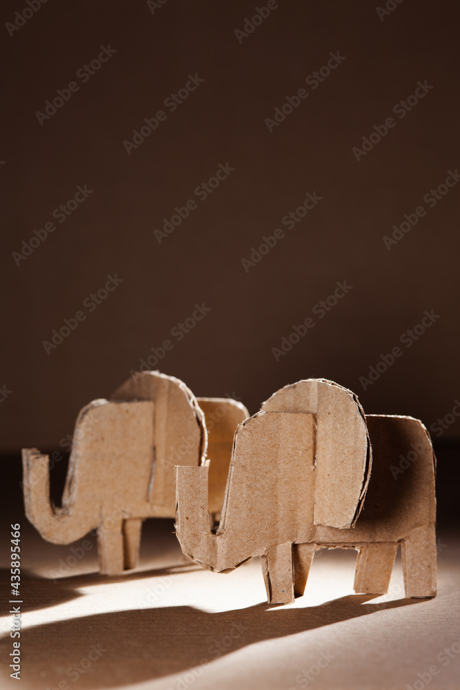 Elephant made of cardboard on a dark background. Children art project ...