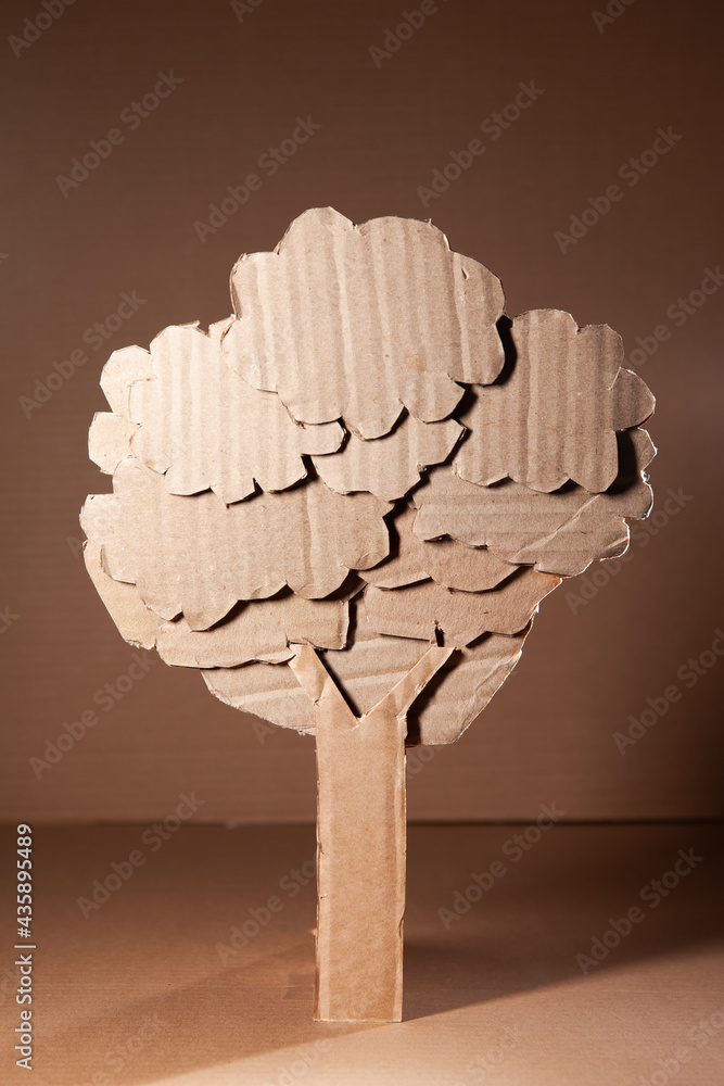 Tree made of cardboard on a degrade background. Children art project ...