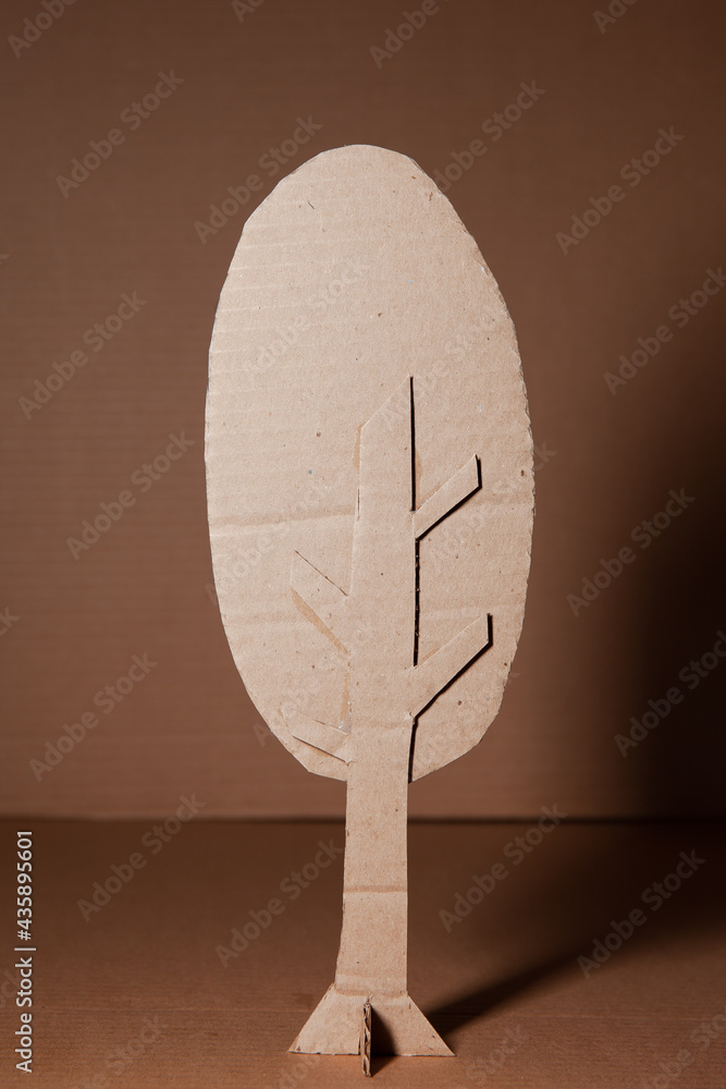 Tree made of cardboard on a degrade background. Children art project ...