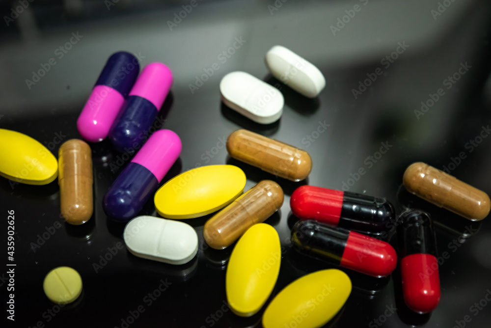 Pharmaceutical medicine pills in both tablets and capsules with the ...