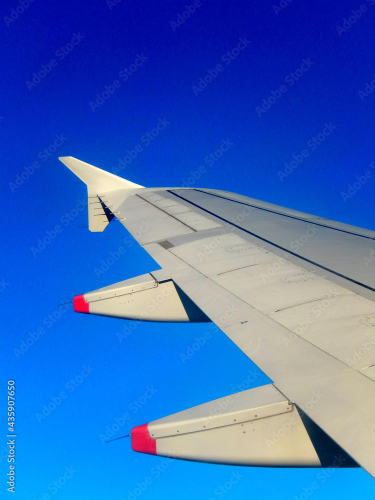 Wing of a commercial jet with a winglet for fuel efficiency against a ...
