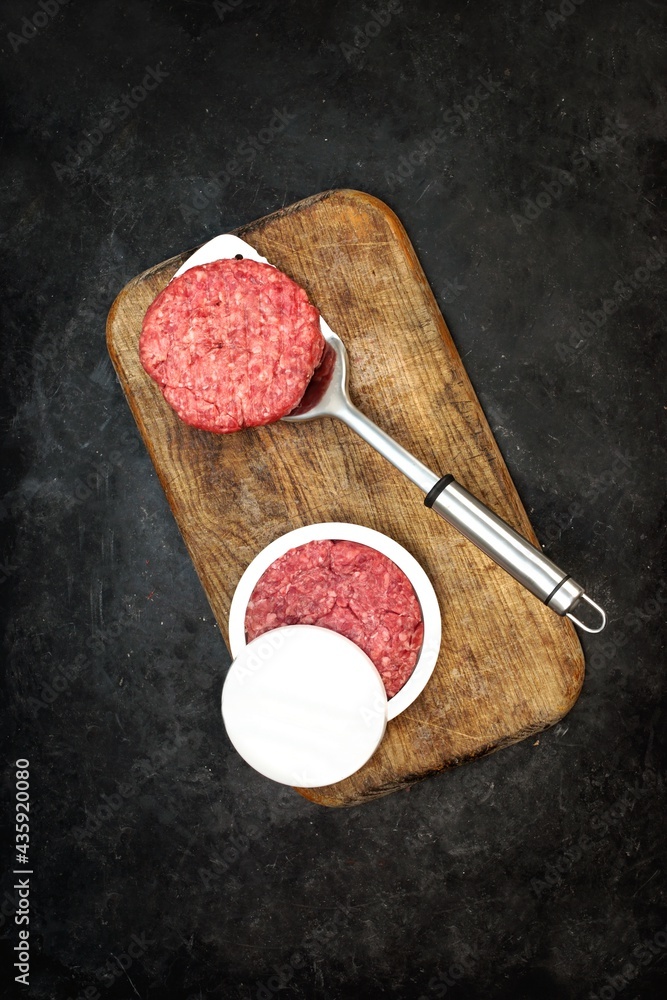 Patty Press with Burgers on Wooden Board on Black Background, Overhead ...