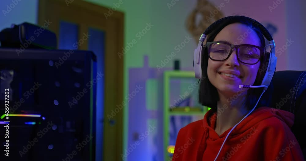 Portrait of a beautiful woman gamer getting ready to play the cyber ...