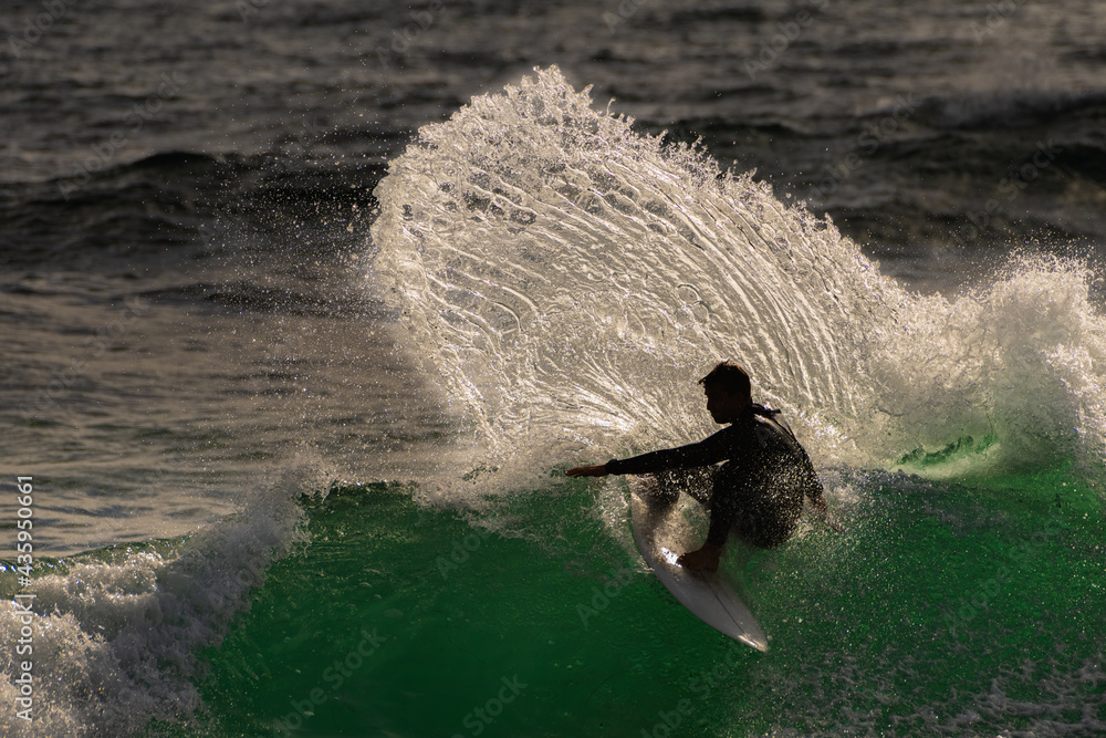2021-05-23 SURFER CUTTING A WAVE WITH A LARGE SHEET OF WATER IN THE ...