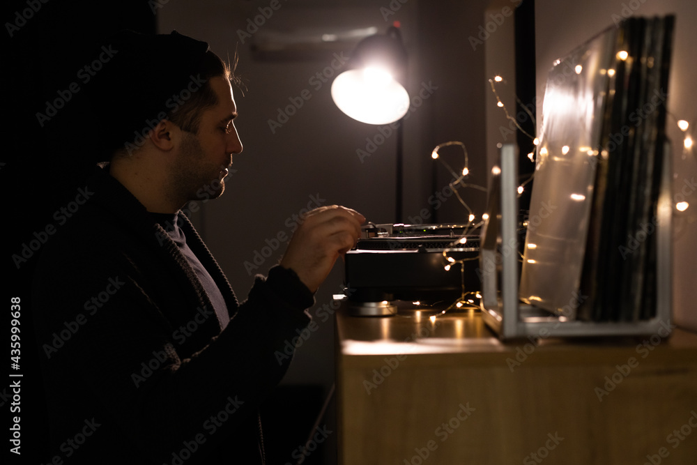 audiophile enjoys sound of retro vinyl records Relaxed lounging at home ...