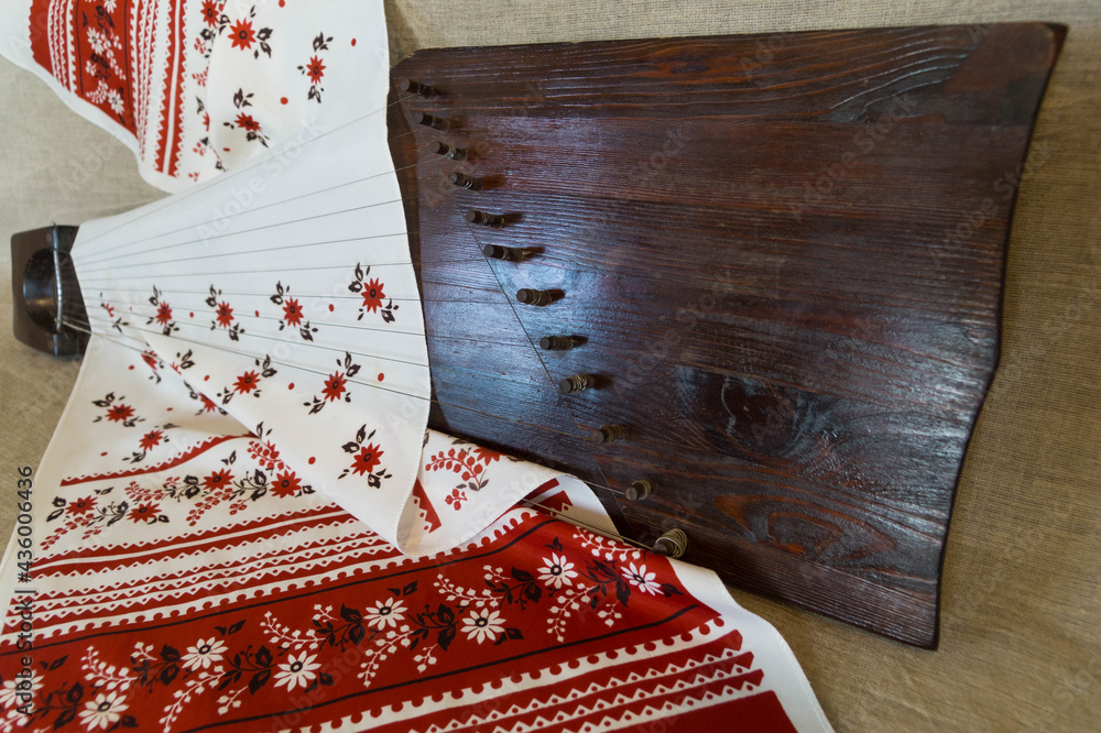 Wing-shaped brown wooden gusli - an ancient Slavic stringed plucked ...