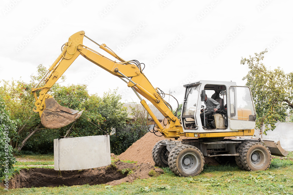 Hydraulic piston system of the excavator with a bucket, lowering into ...