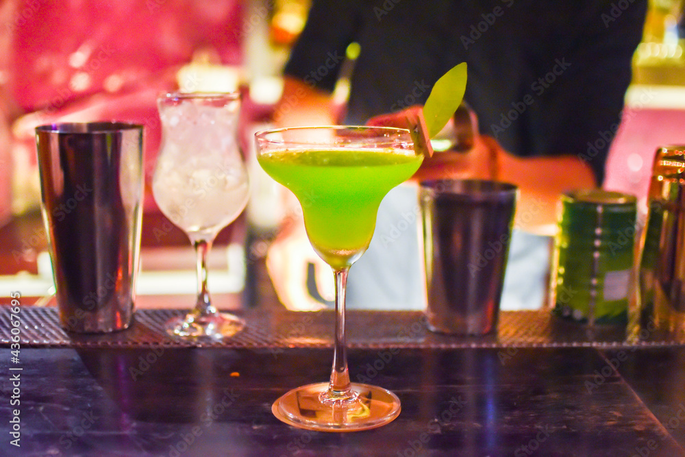 Art of mixology at a classic bar counter with green rice cocktail in a ...