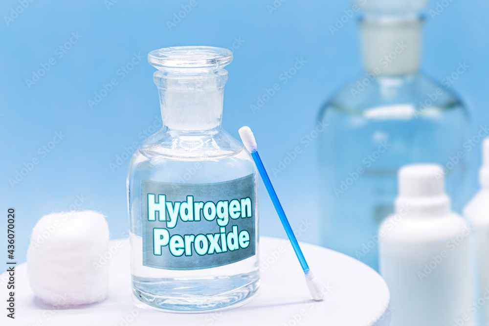 glass hospital container with antiseptic, written in English hydrogen ...