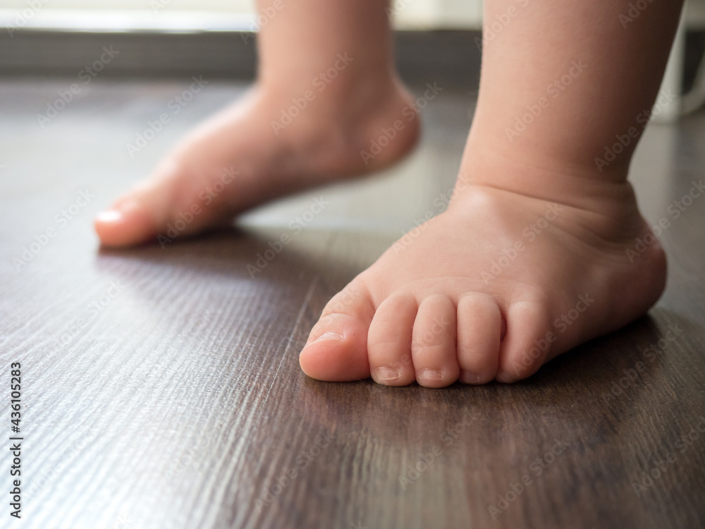 Children's feet take their first steps. The first steps of a child ...