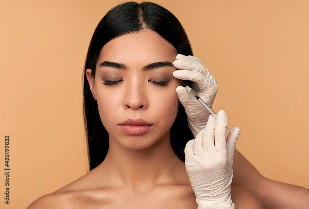 Young Asian woman with clean radiant skin gets botox injections for ...