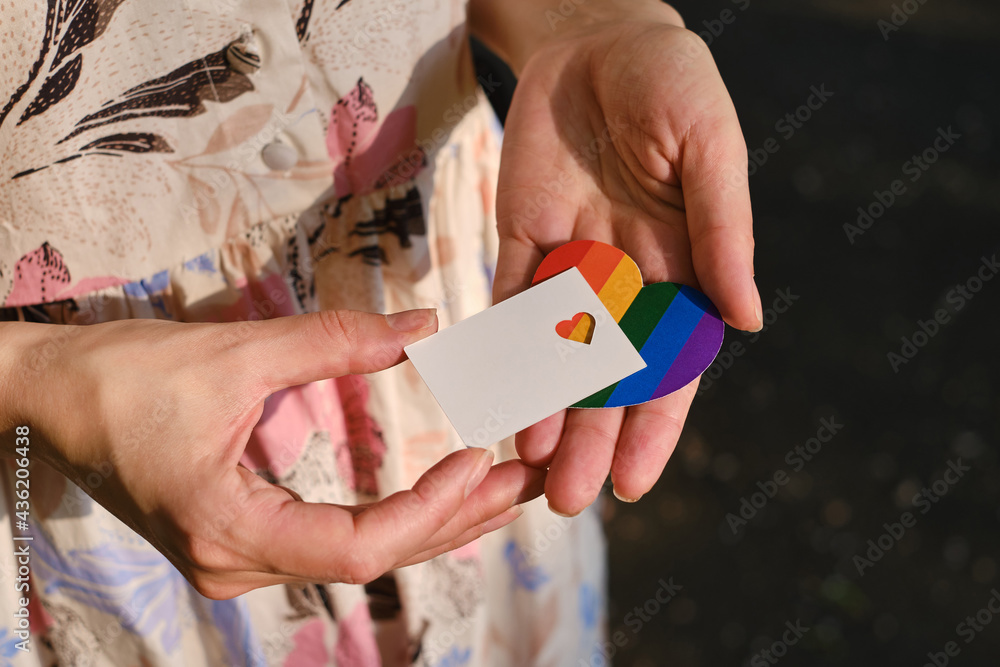 Rainbow heart from paper and a white card for a message in a woman ...