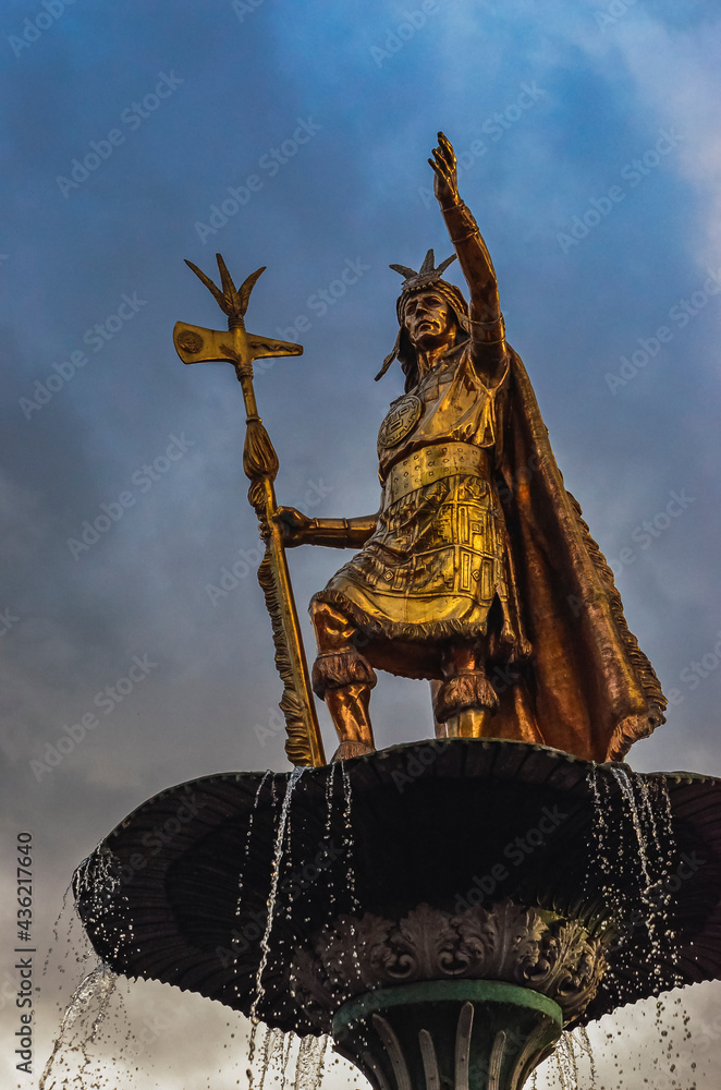 Golden sculpture of inca Pachacutec in Cusco with cloudy dark sky ...