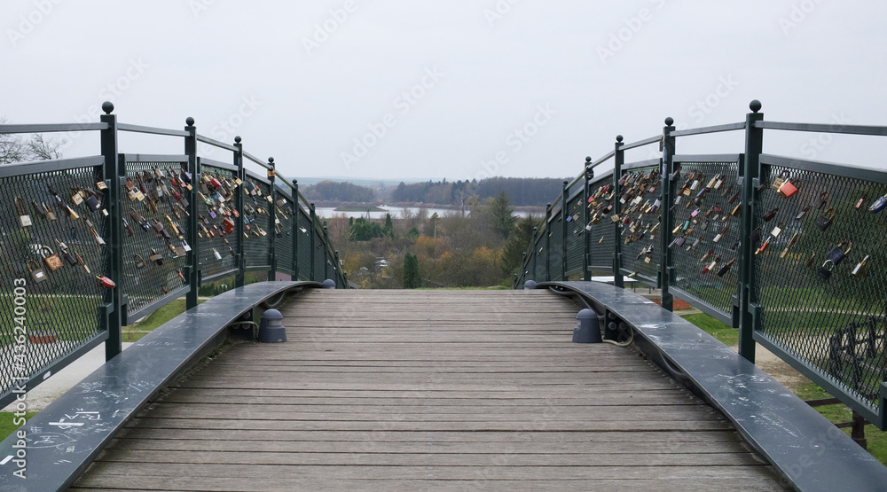 Lots of padlocks on the railing of the footbridge. Padlocks symbolizing ...