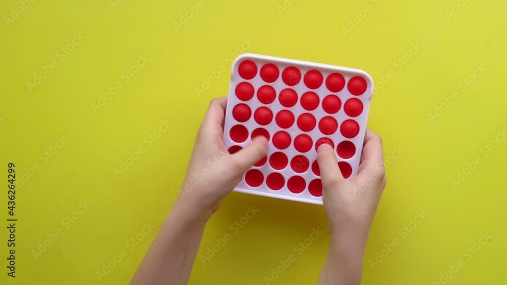 Popit antistress toy for children entertainment on a yellow background ...