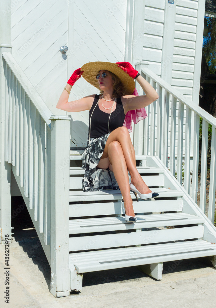 Woman dressed in floral skirt,high heels, nylon stockings, lace gloves ...