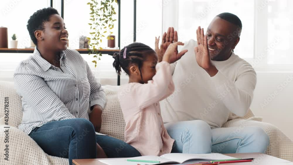 Happy african family afro american parents helping black little girl ...