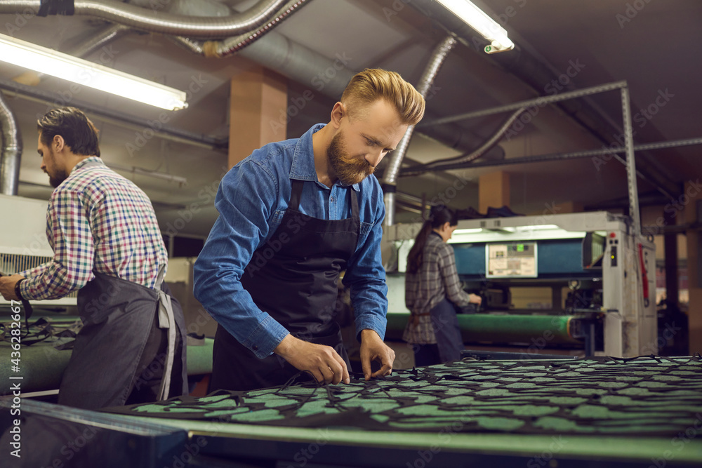 Fashion designer modeling new shoe from skin patterns on worktable ...