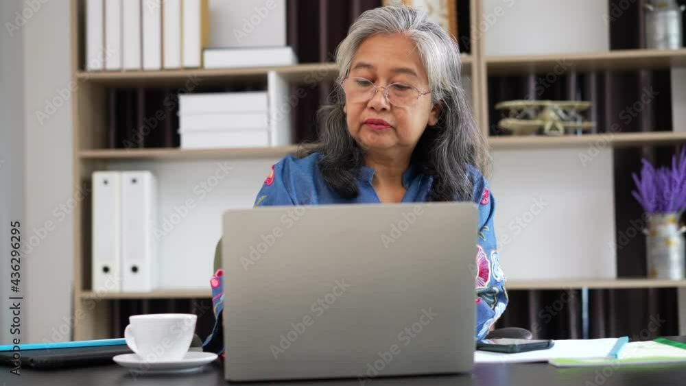 Senior woman working with smartphone and laptop computer Stock ビデオ ...