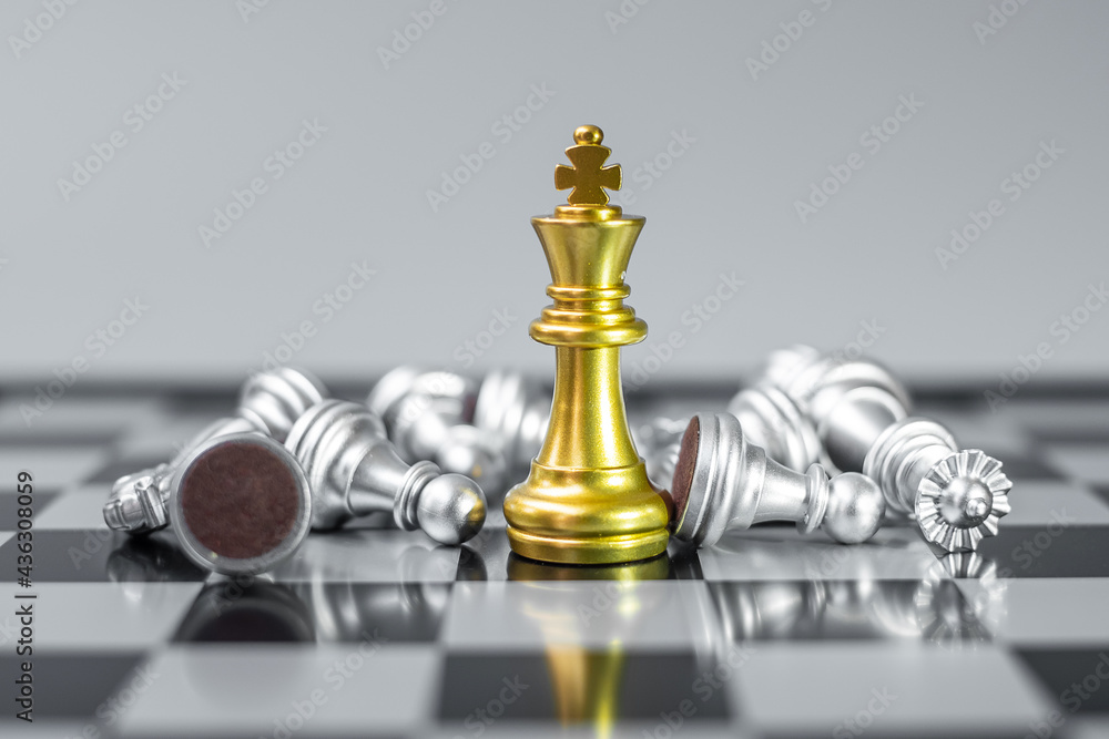 Chess king figure stand out from crowd of enermy or opponent during ...