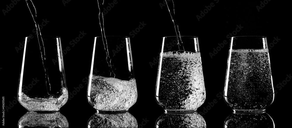 stages of pouring water into glass beaker on black background Stock ...
