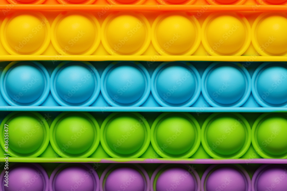 Rainbow pop it fidget toy as background, closeup 스톡 사진 | Adobe Stock